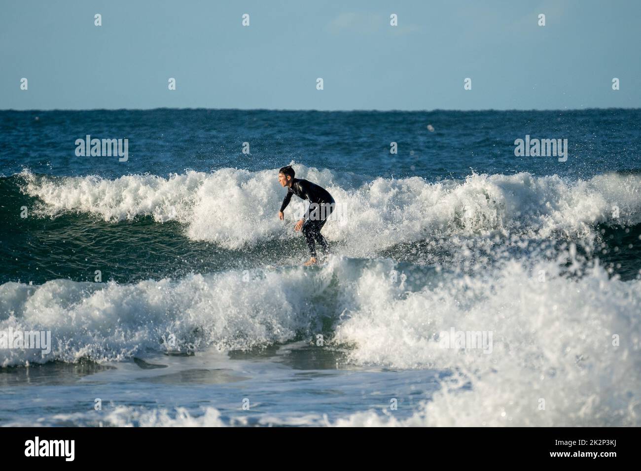 A surfer at Bondi Beach, Australia, on Saturday morning having fun and ...