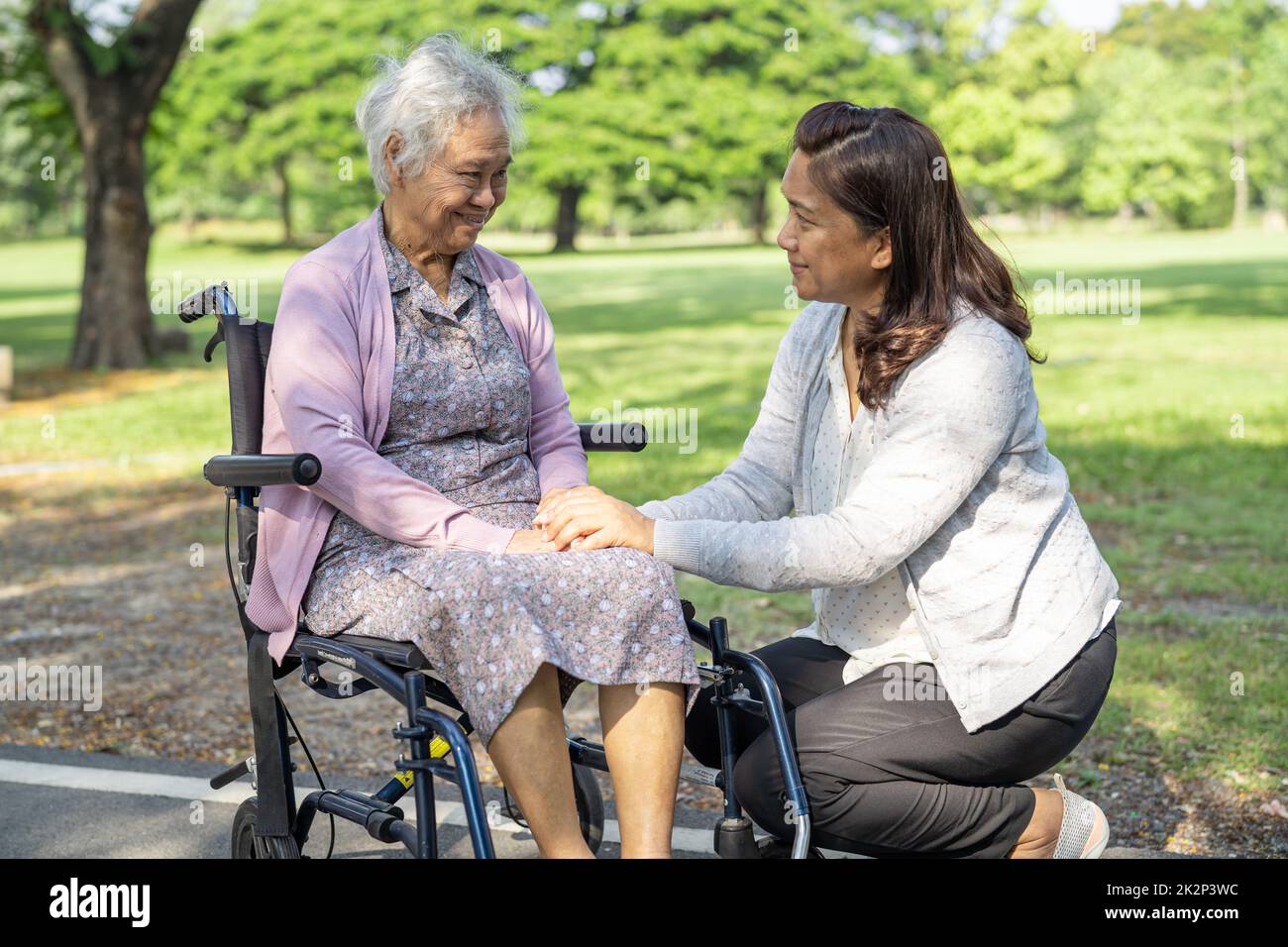 Caregiver help and care Asian senior or elderly old lady woman patient sitting and happy on ...