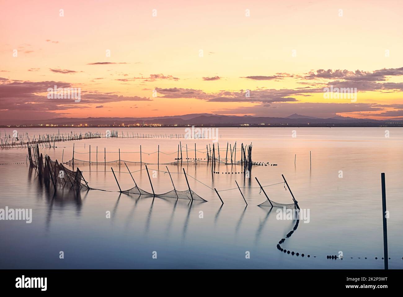 Sunset on the Valencia lagoon between the nets Stock Photo - Alamy