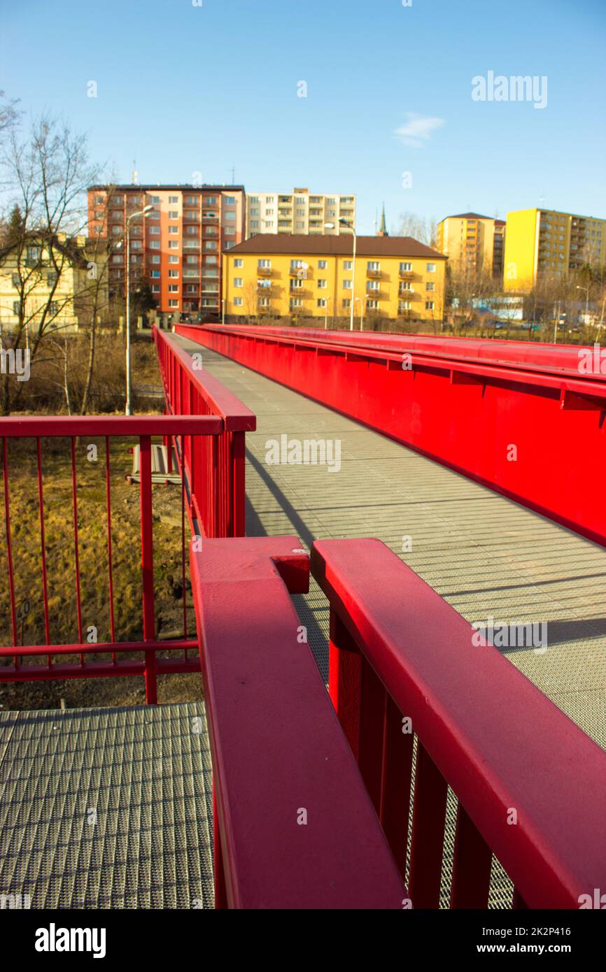 Steel red bridge over railway and block of flats Stock Photo - Alamy