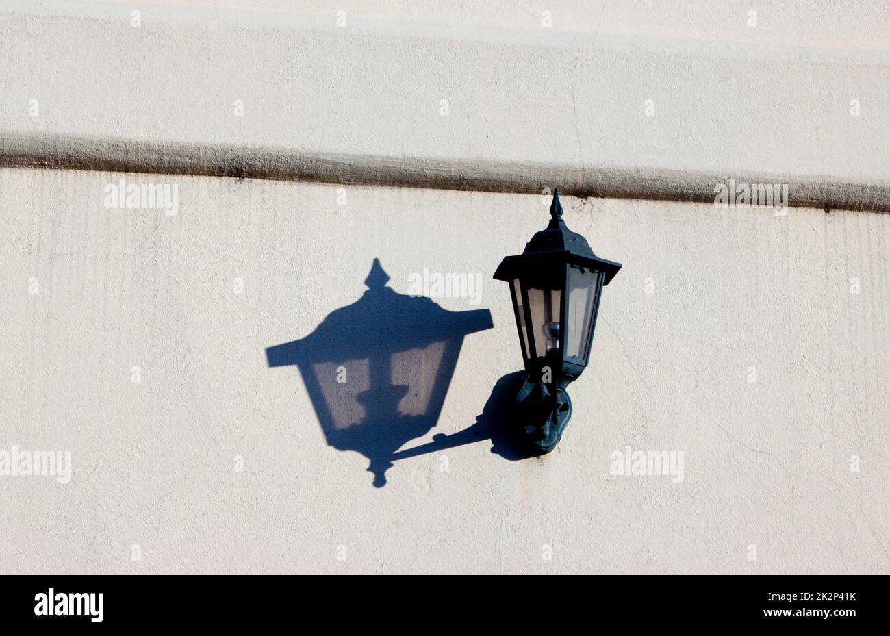 Street lamp mounted on the wall and its shadow Stock Photo - Alamy