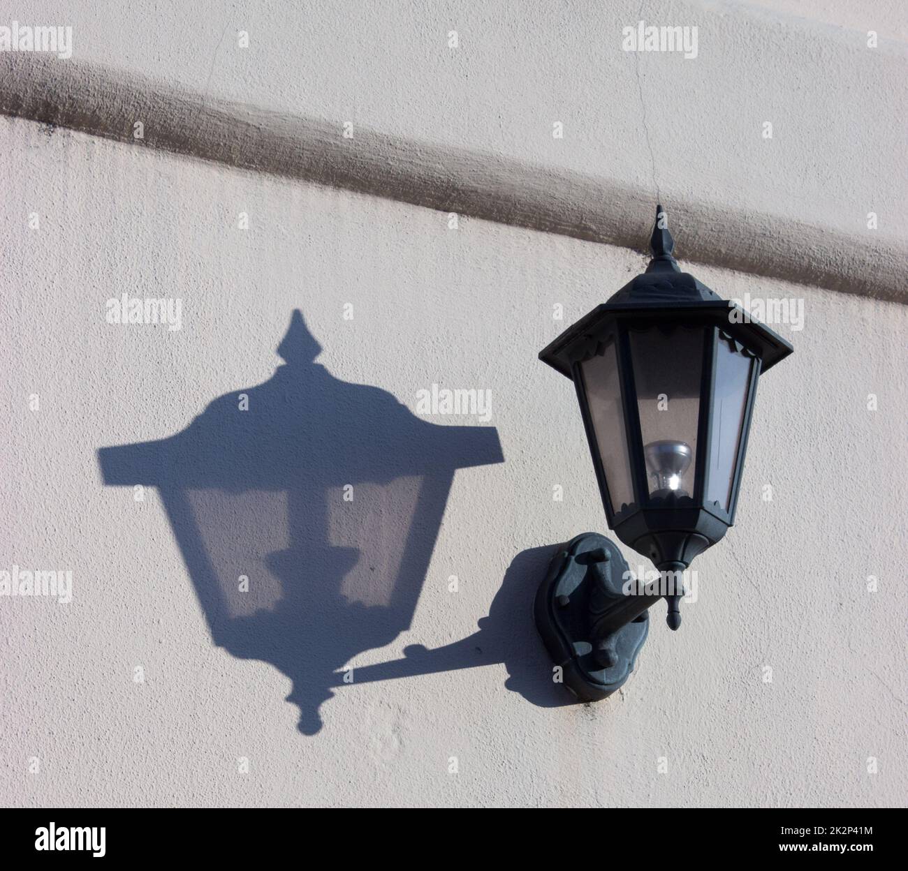Street lamp mounted on the wall and its shadow Stock Photo - Alamy