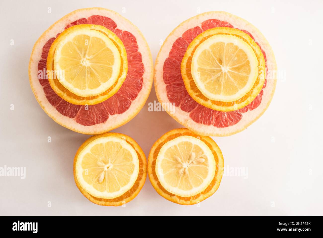 Citrus fruits being cut in half Stock Photo - Alamy