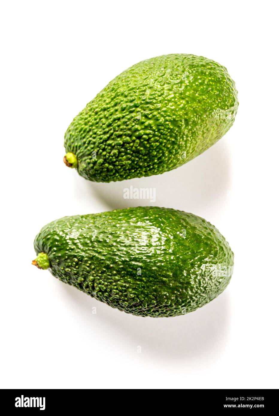 Two avocados isolated on a white background Stock Photo - Alamy