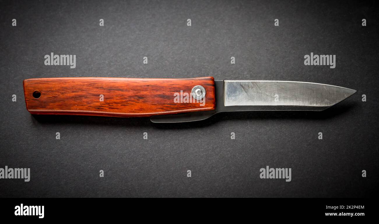 Traditional wooden japanese pocket knife on black background Stock ...