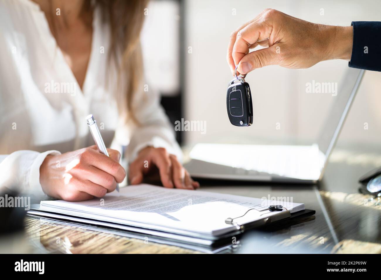 Female customer receiving car key hi-res stock photography and images ...