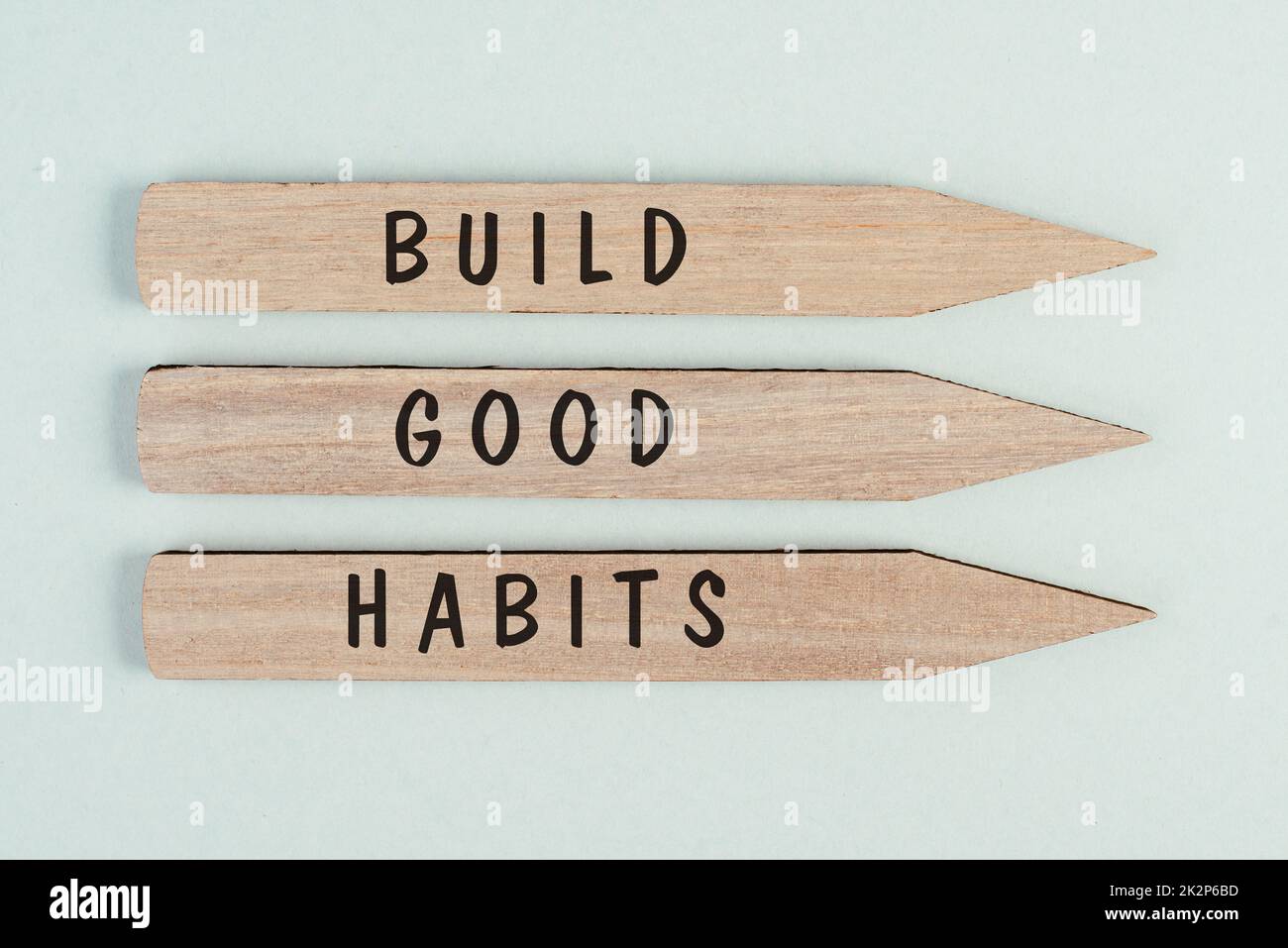 The words build good habits are standing on arrows, change lifestyle ...