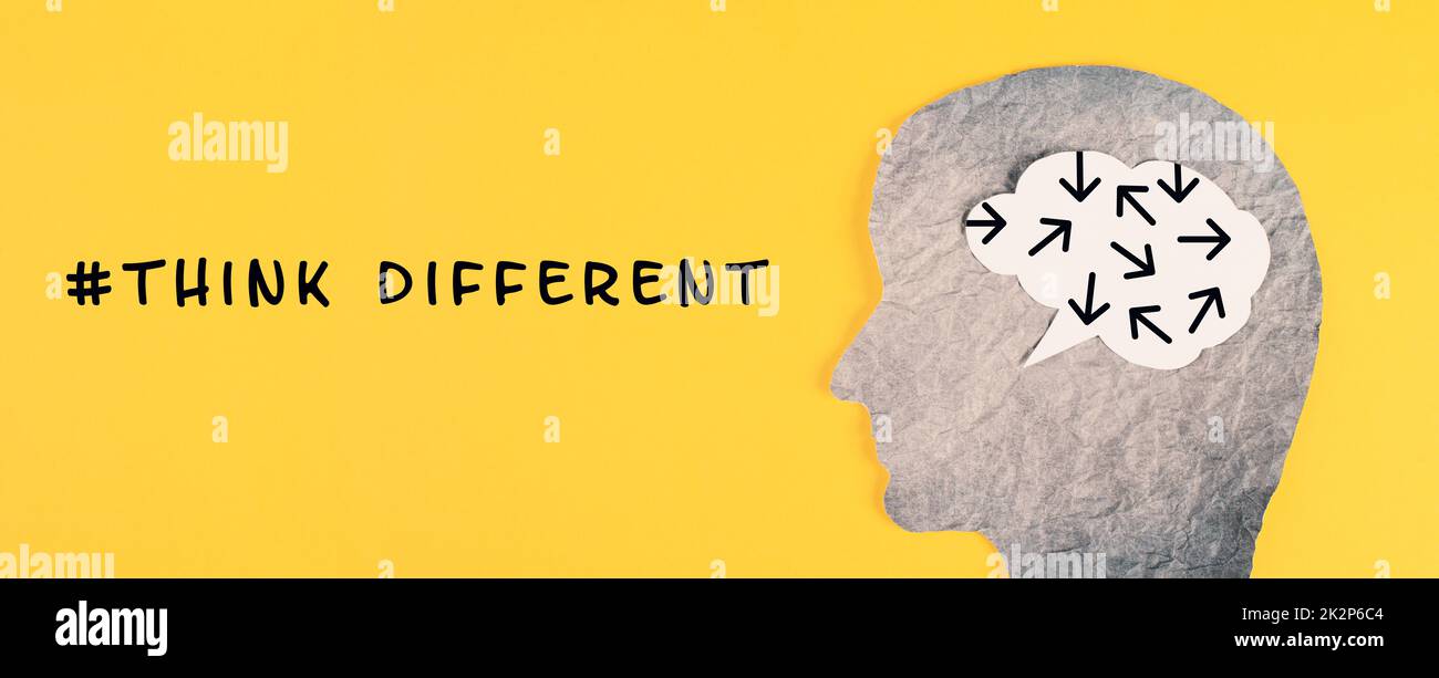 Think different stands on the yellow background, head with brain, being ...