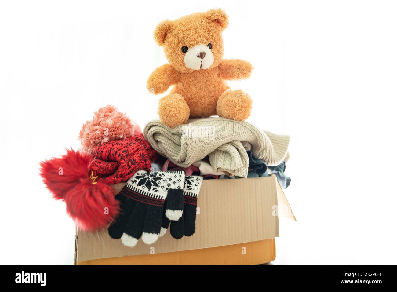 Donation box with used clothes and teddy bear at home to support help ...