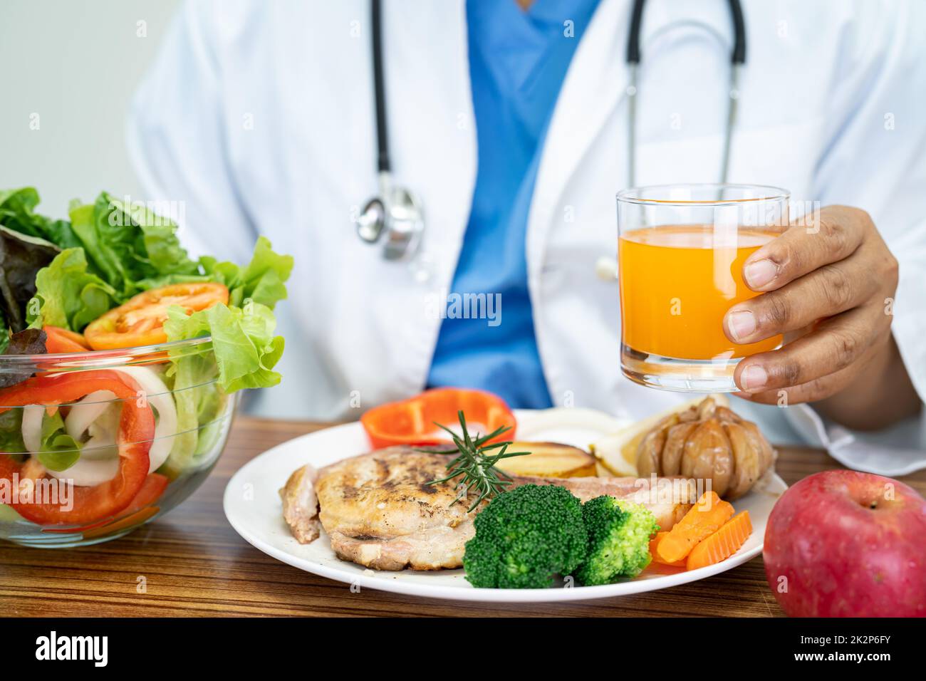 Nutritionist doctor with various healthy fresh vegetables for patient ...