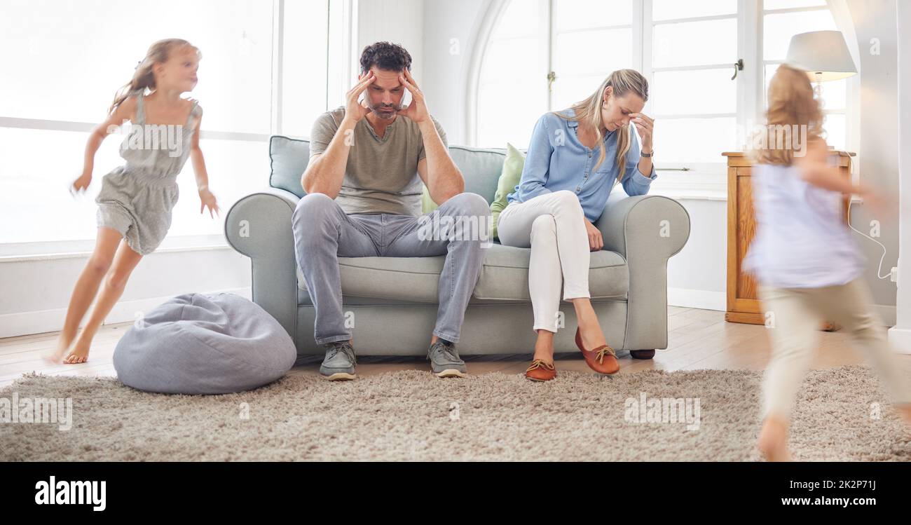 Parents headache, running children and family stress in home living room, anxiety from happy ...