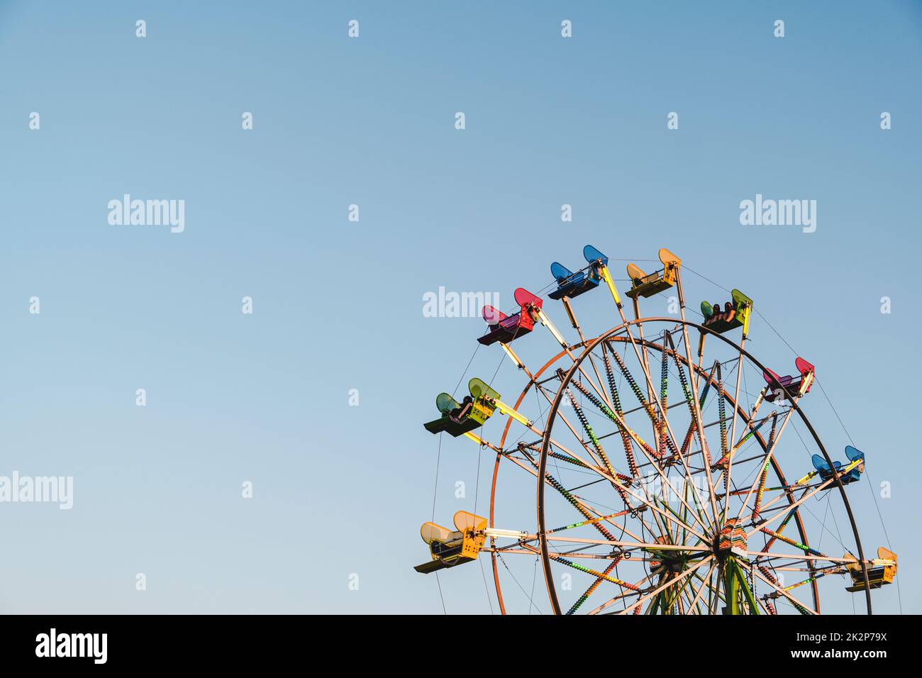 A colorful ferris wheel ride in background of blue sky in Decatur Stock ...
