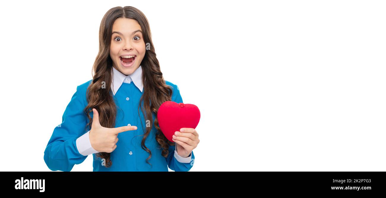 Surprised child with open mouth point index finger at red heart ...