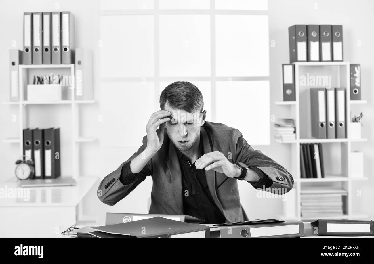 businessman working in office with headache. male manager work on ...