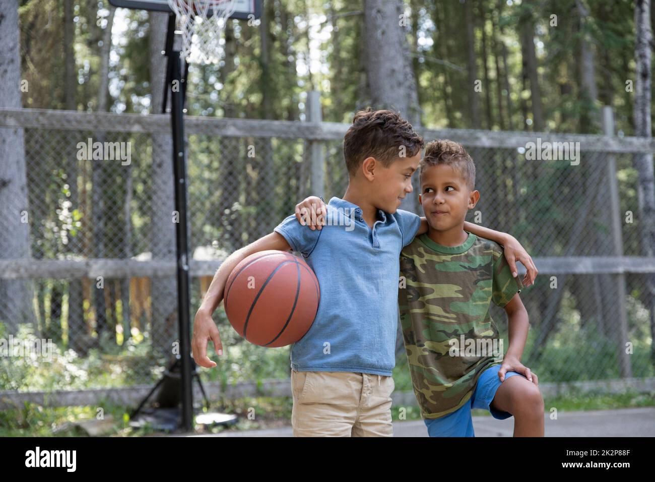 Brothers playing basketball at summer camp Stock Photo - Alamy