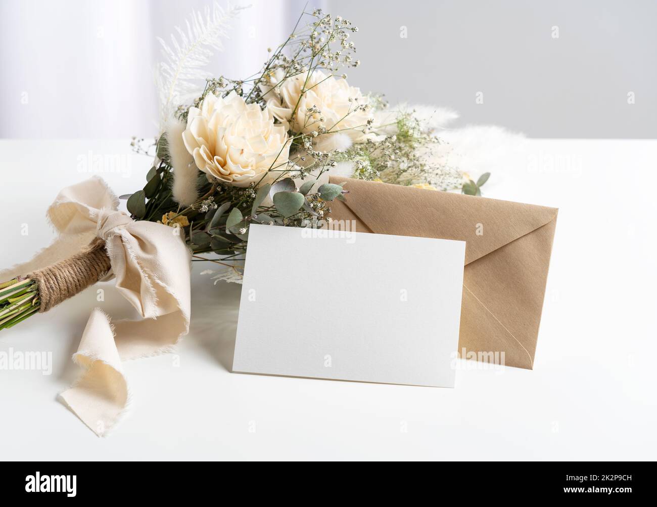 Dried flower bouquet and blank message card placed on white background ...