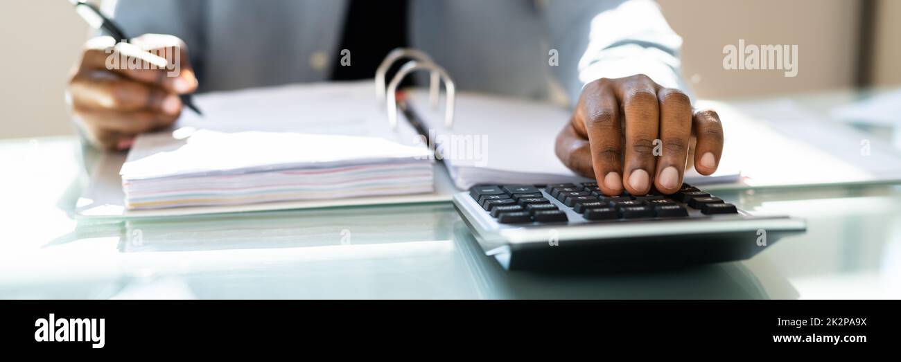 African American Male Accountant Using Calculator Stock Photo - Alamy