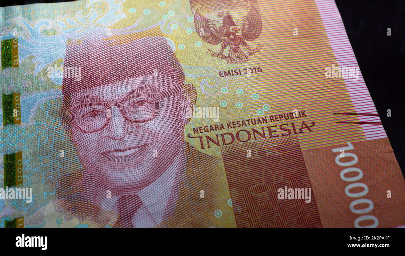 Indonesian money is one hundred thousand rupiah Stock Photo - Alamy