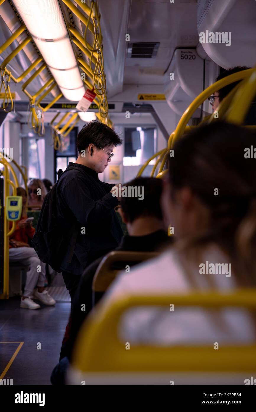 The vertical view of people sitting and standing on the bus Stock Photo ...