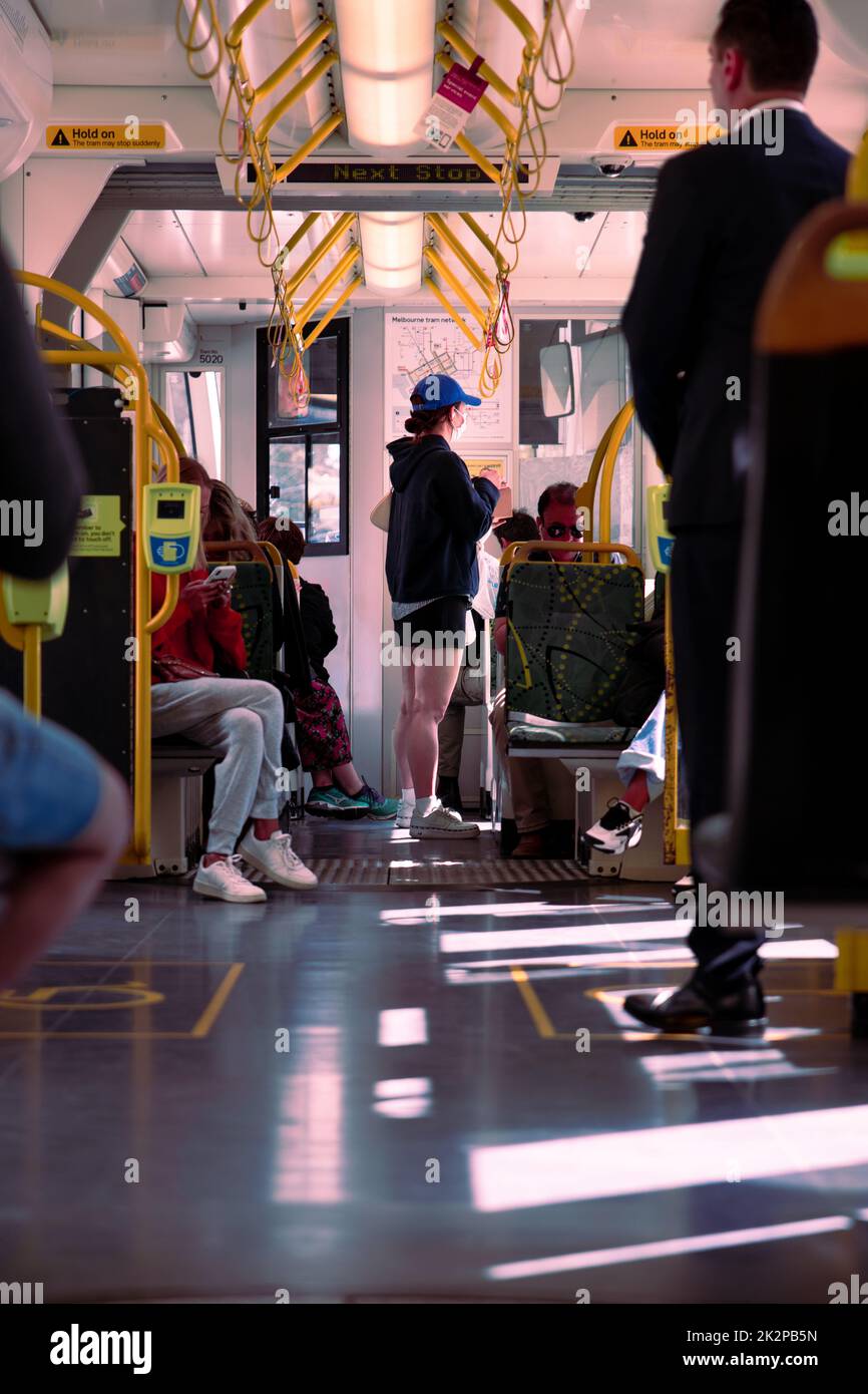 The vertical view of people sitting and standing on the bus Stock Photo ...