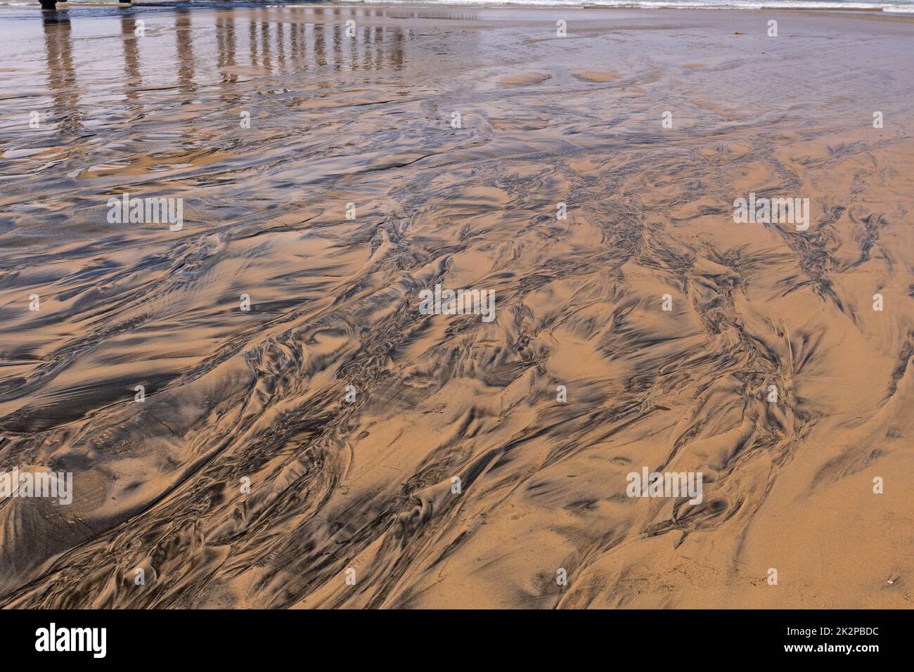 Colorful Sand Where Water Flows to the Ocean Stock Photo - Alamy