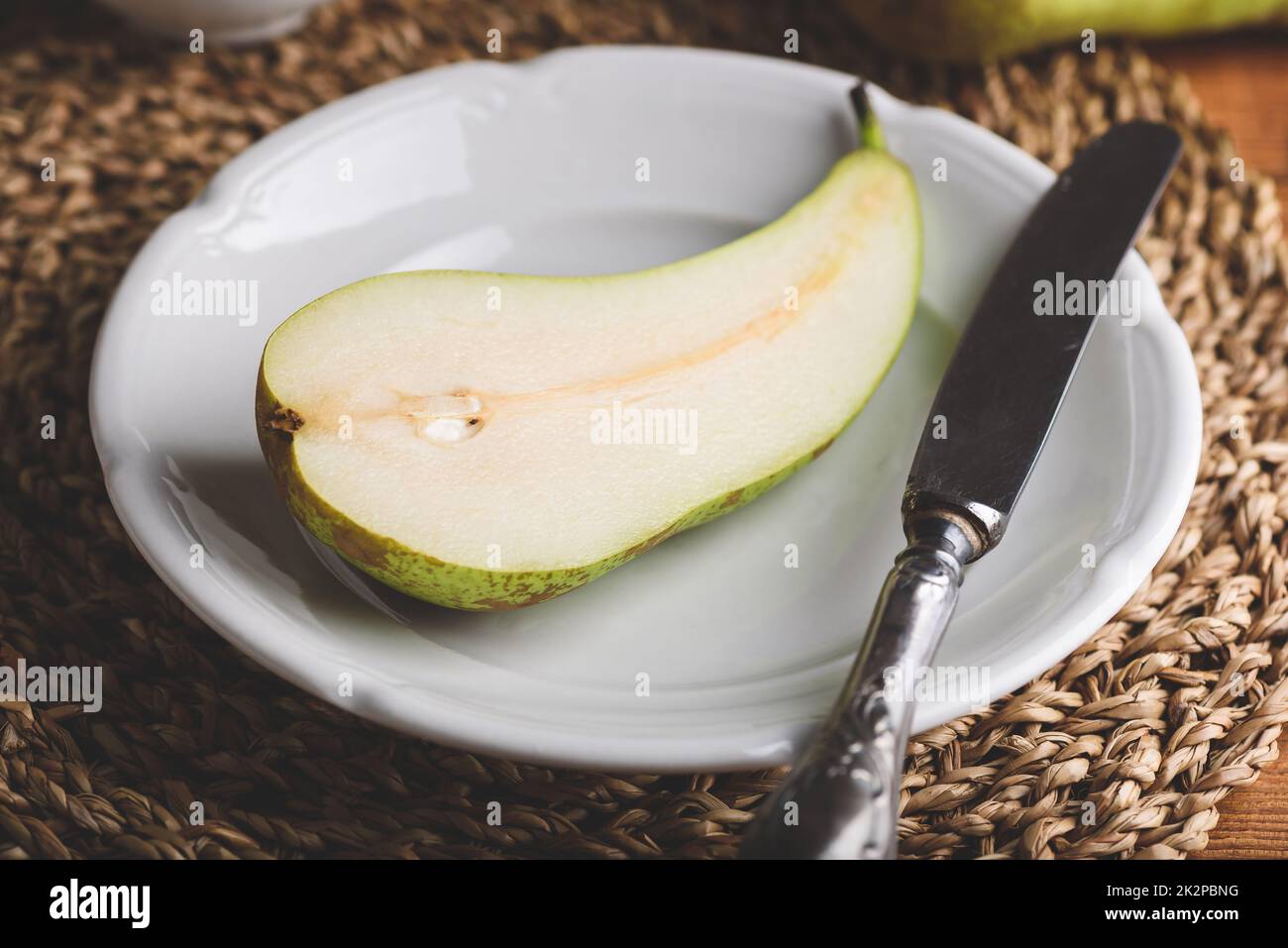 Half of Conference Pear on Plate Stock Photo - Alamy