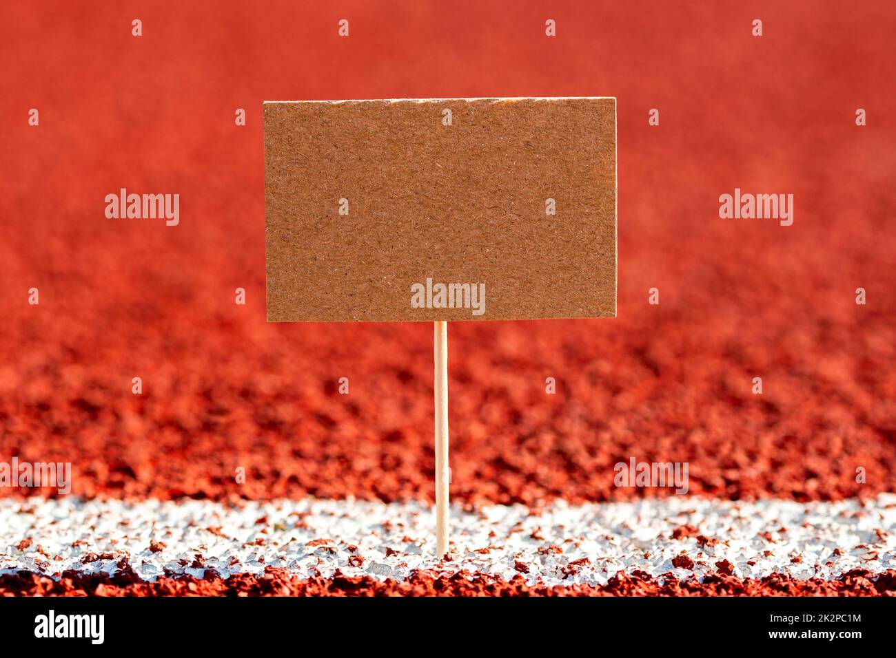 Blank mini paper pointer on a red running track Stock Photo - Alamy