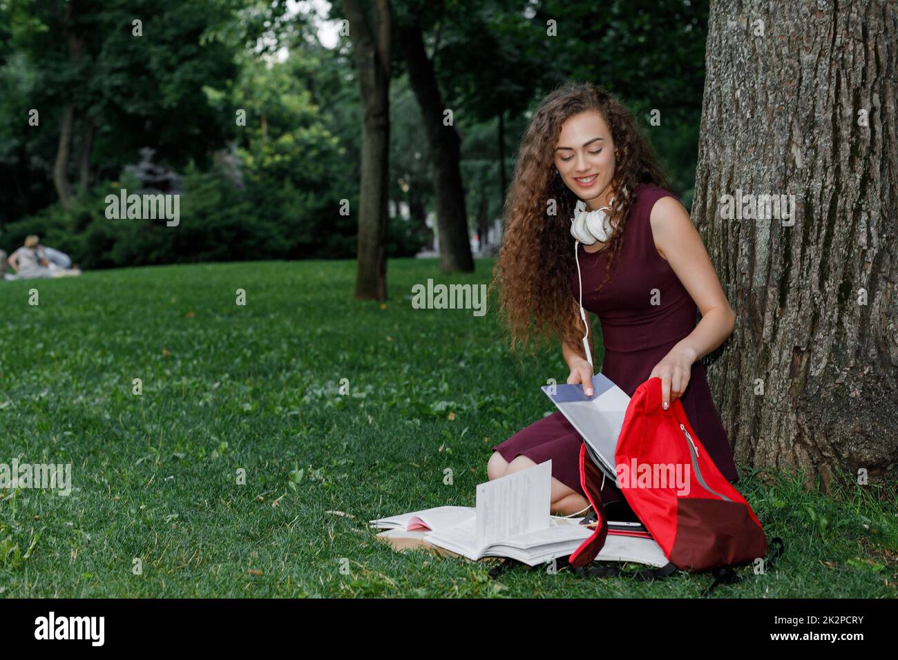 Teenager sitting under tree hi-res stock photography and images - Alamy