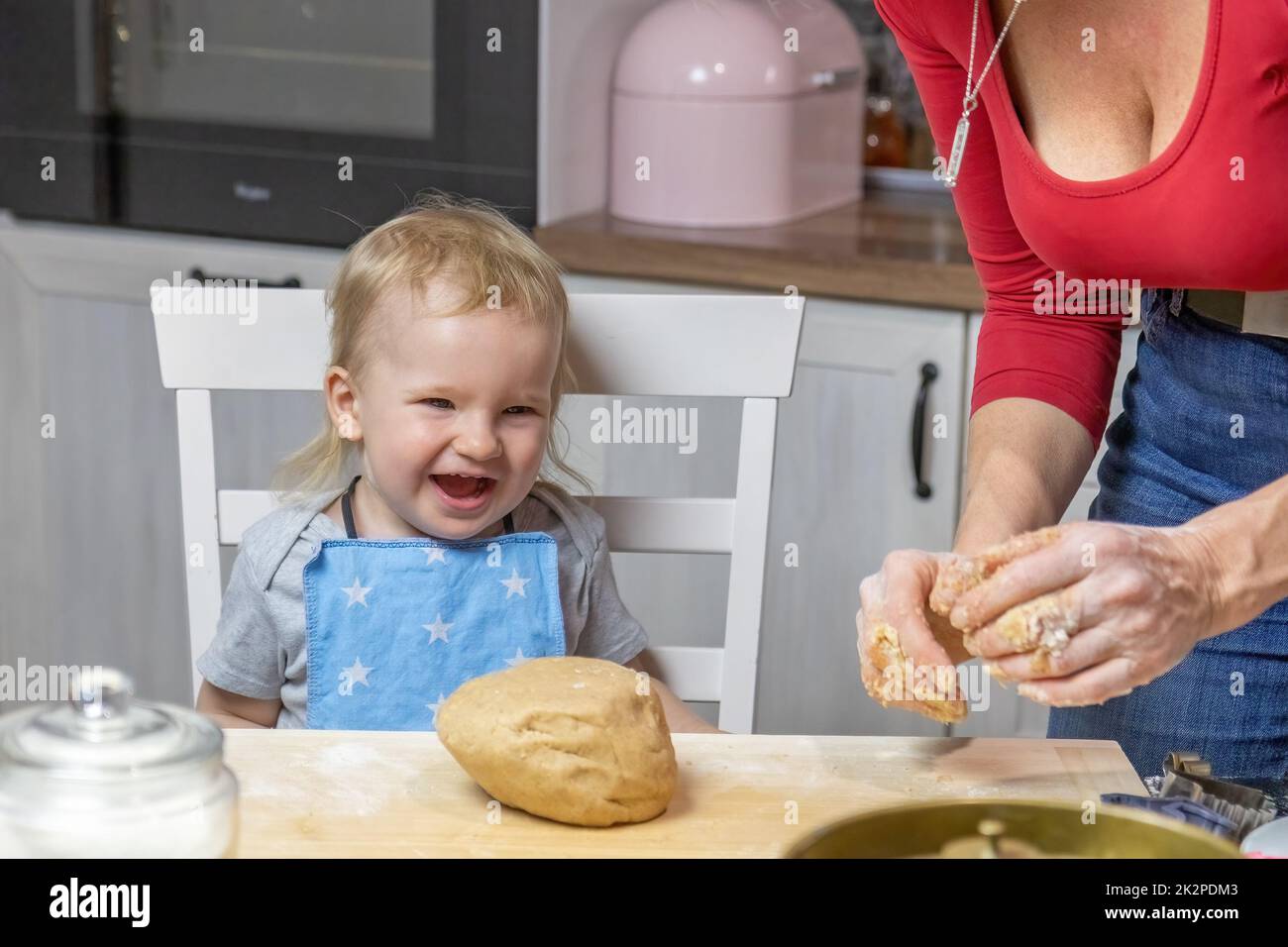 Smiling little child boy is baking cake in domestic kitchen Stock Photo ...