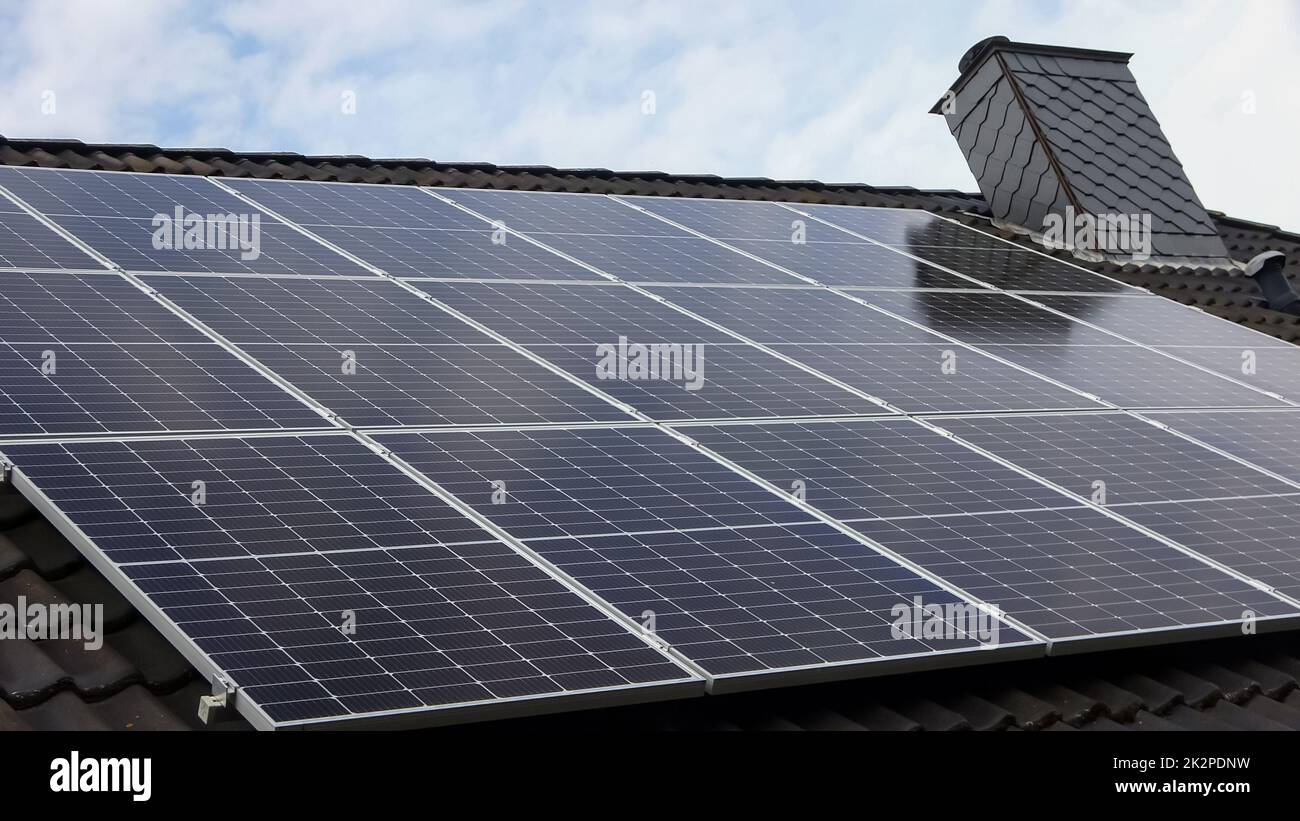 Solar panels producing clean energy on a roof of a residential house ...