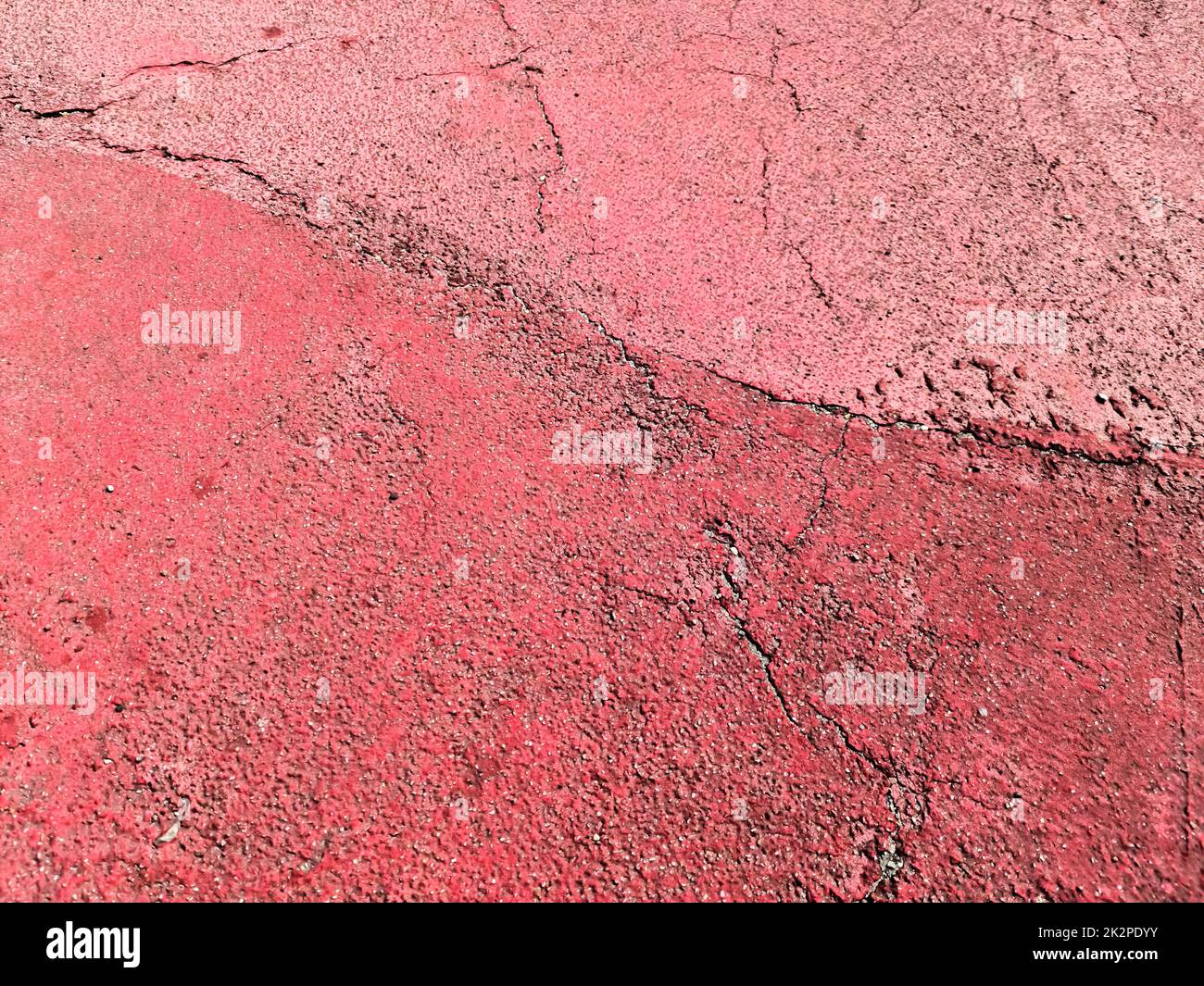 Asphalt surfaces of damaged streets and roads with cracks in a close up ...