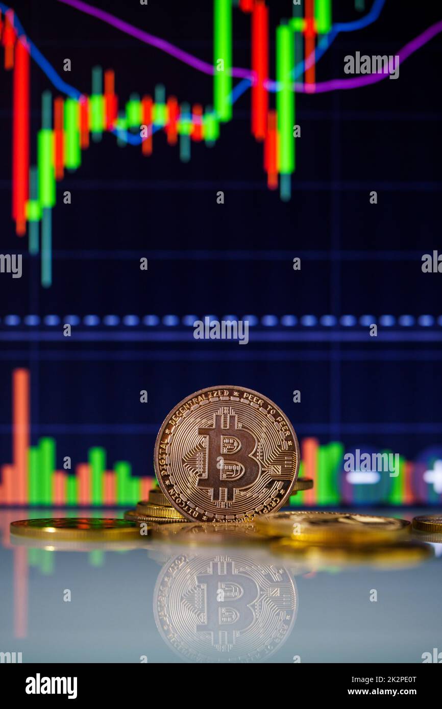 Gold Bitcoins with candle stick graph chart and digital background ...