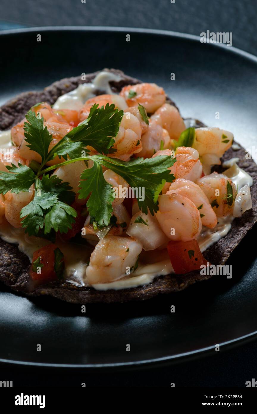 Red shrimp ceviche and blue corn tostadas Stock Photo - Alamy