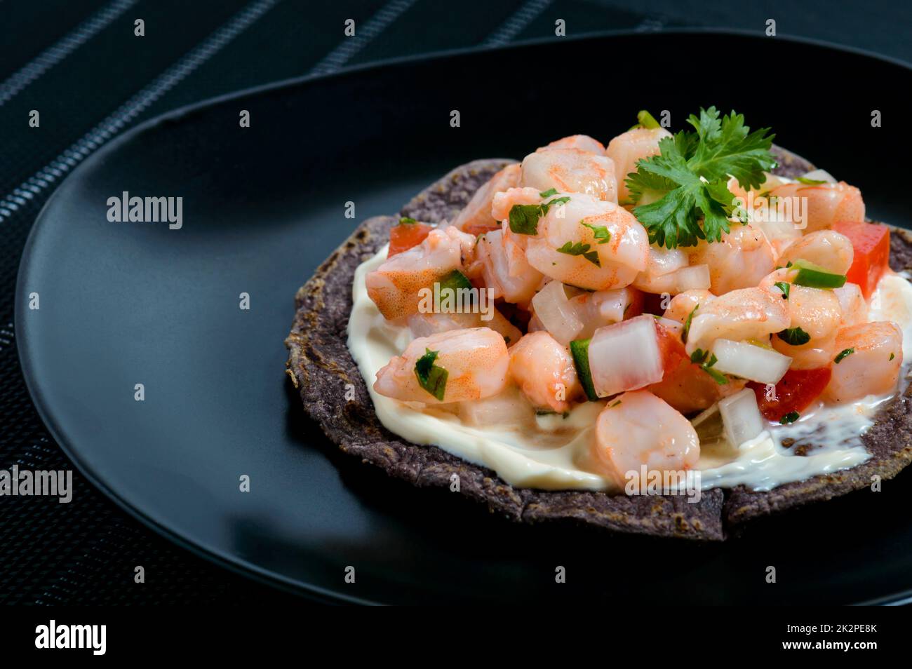 Red shrimp ceviche and blue corn tostadas Stock Photo - Alamy