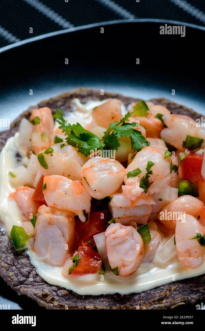 Red shrimp ceviche and blue corn tostadas Stock Photo - Alamy