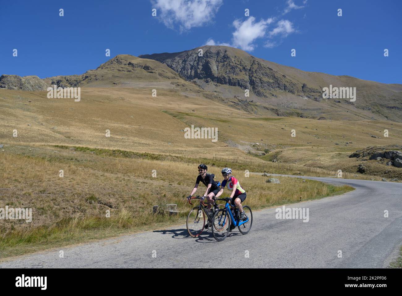 Mother and son cycling on the Col de Sarenne, Grandes Rousses massif ...