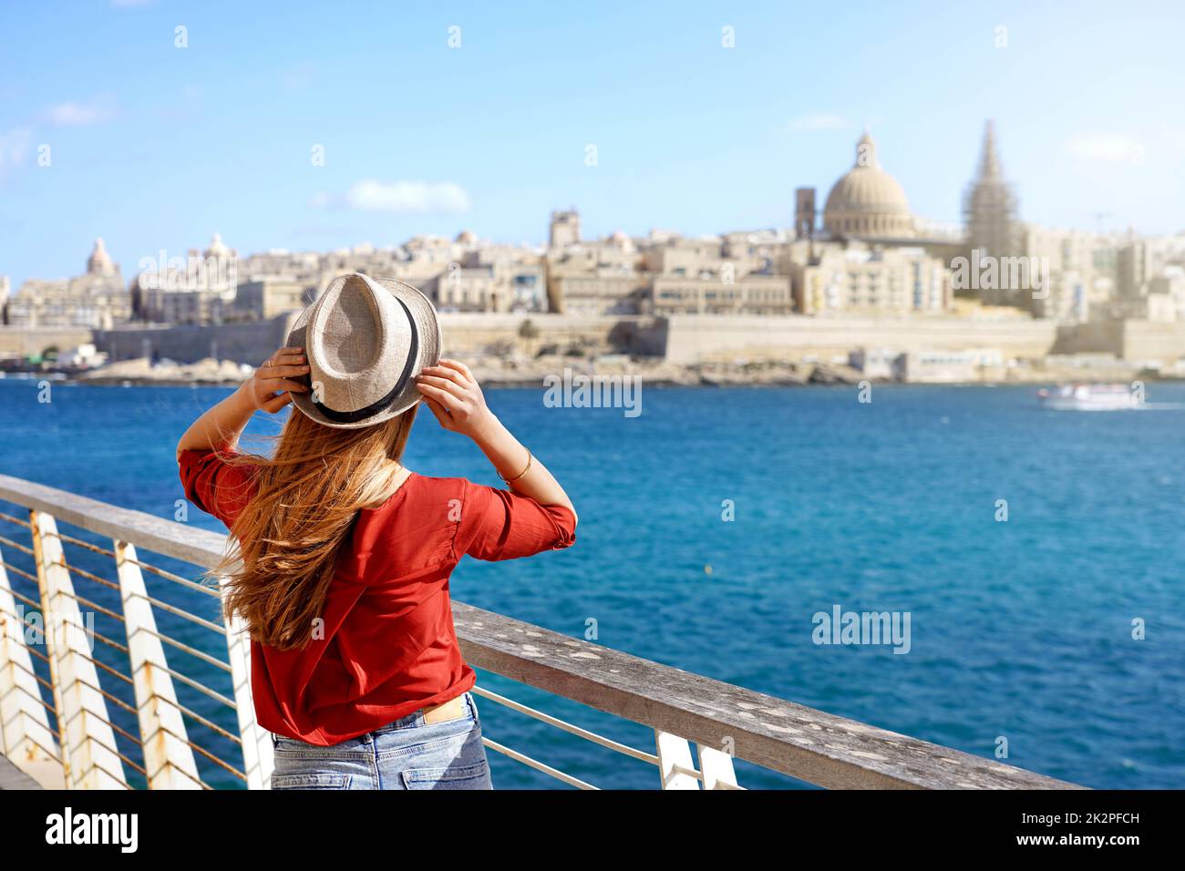 Tourism in Europe. Traveler girl holding hat walking along Malta ...