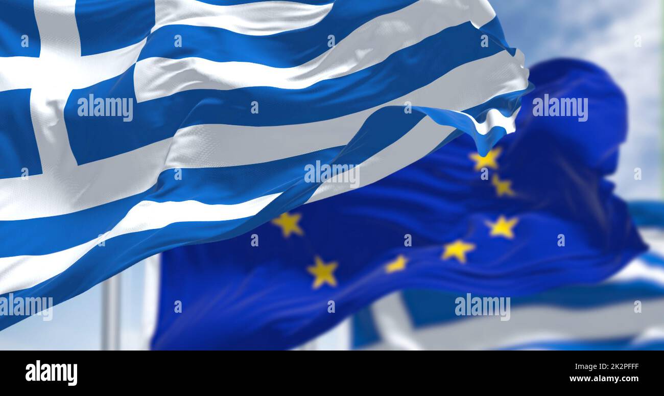 Detail of the national flag of Greece waving in the wind with blurred ...