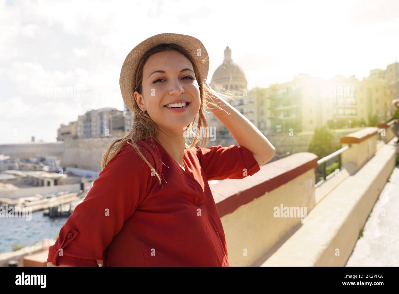 Portrait of smiling relaxed traveler woman walking along Valletta ...