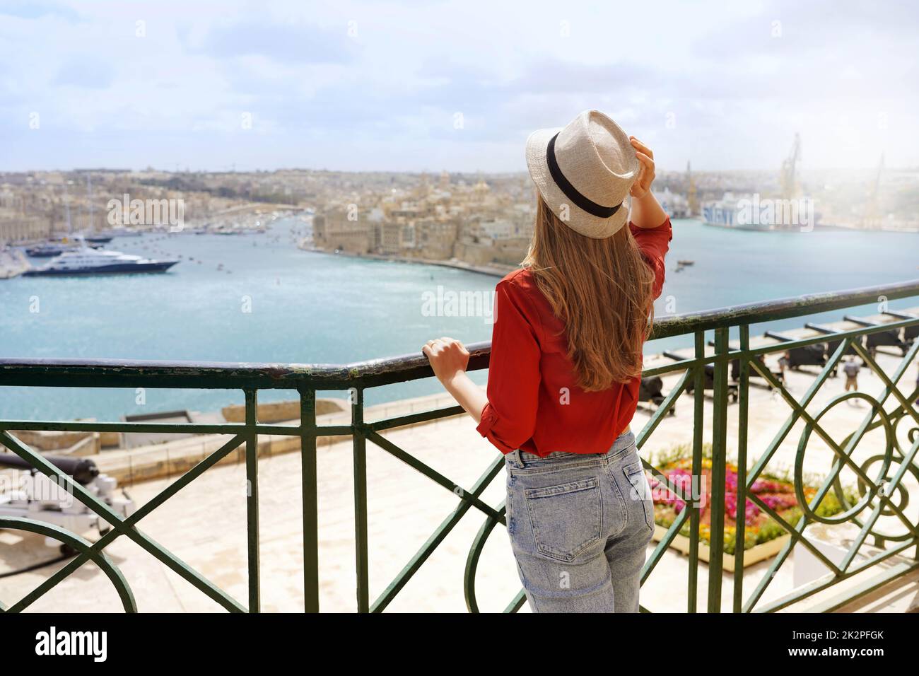Tourism in Malta. Back view of beautiful girl enjoying view of Three ...