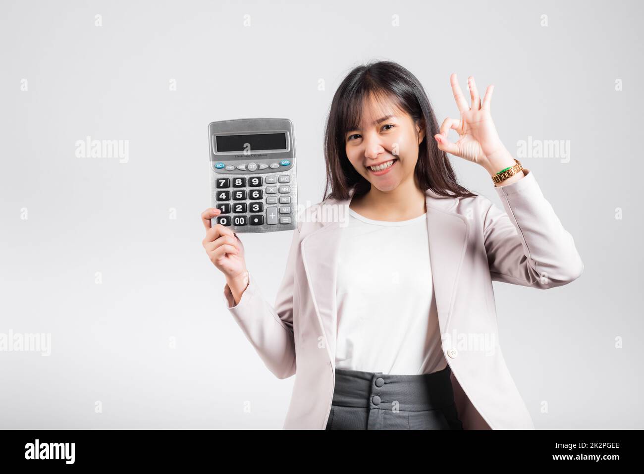 Woman confident smiling holding electronic calculator and show OK ...
