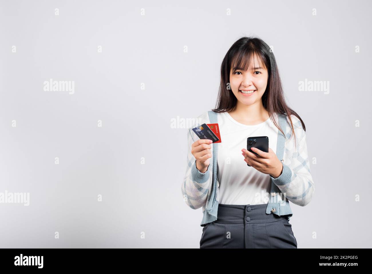 Woman Excited Smiling Hold Mobile Phone And Plastic Debit Credit Bank