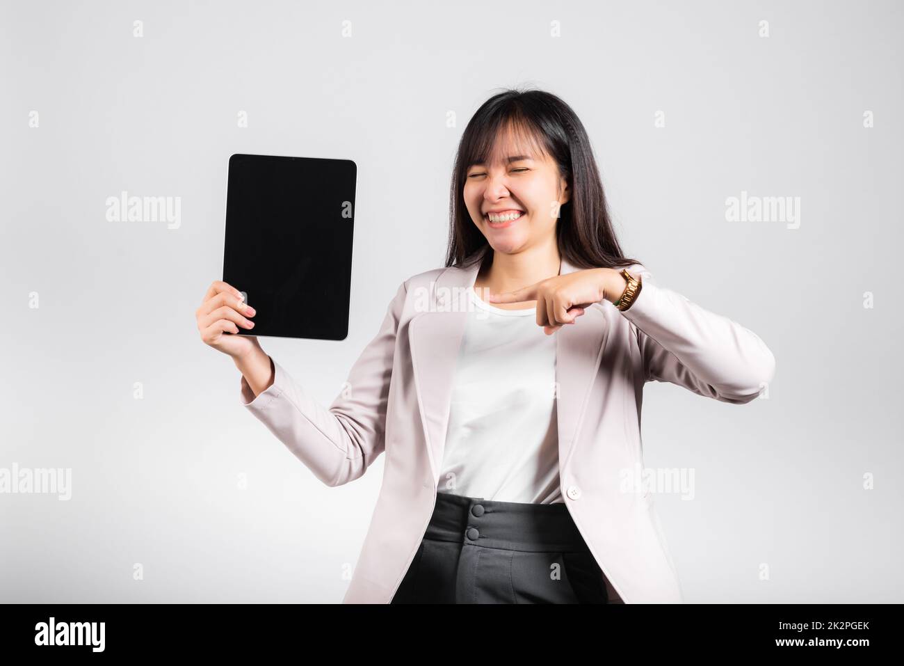 Happy female show blank screen digital tablet pc and pointing finger to ...