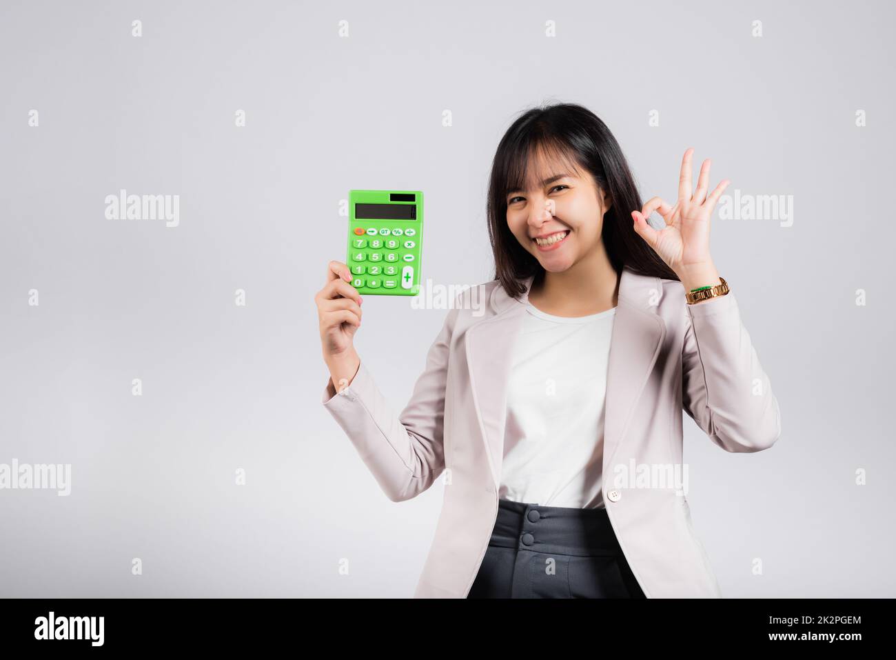 Woman confident smiling holding electronic calculator and show OK ...
