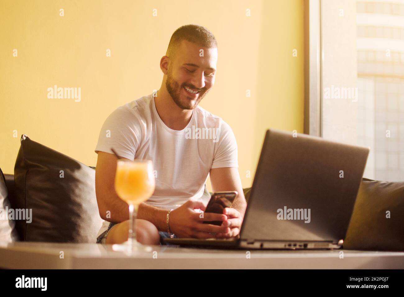 Cheerful guy using laptop typing hi-res stock photography and images ...