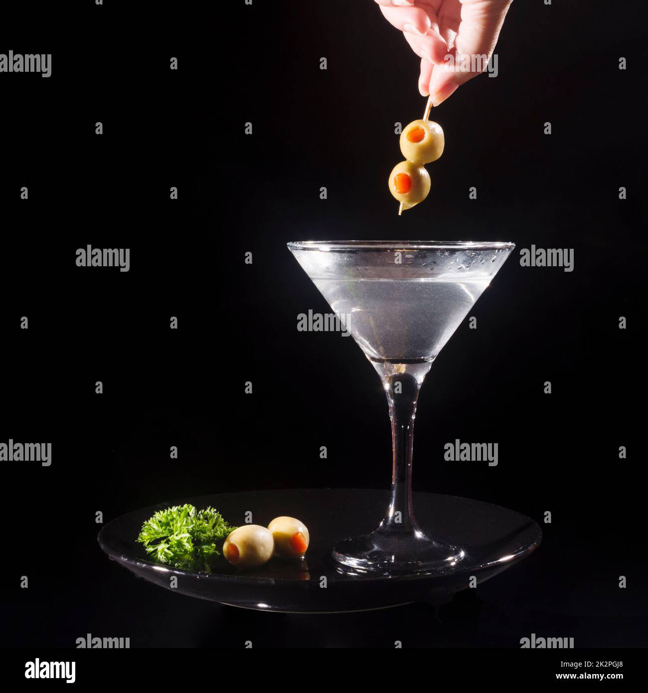 Martini glass olive hand hi-res stock photography and images - Alamy