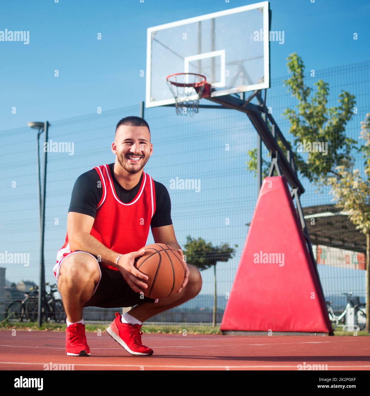 smiling basketball player on playground Stock Photo - Alamy