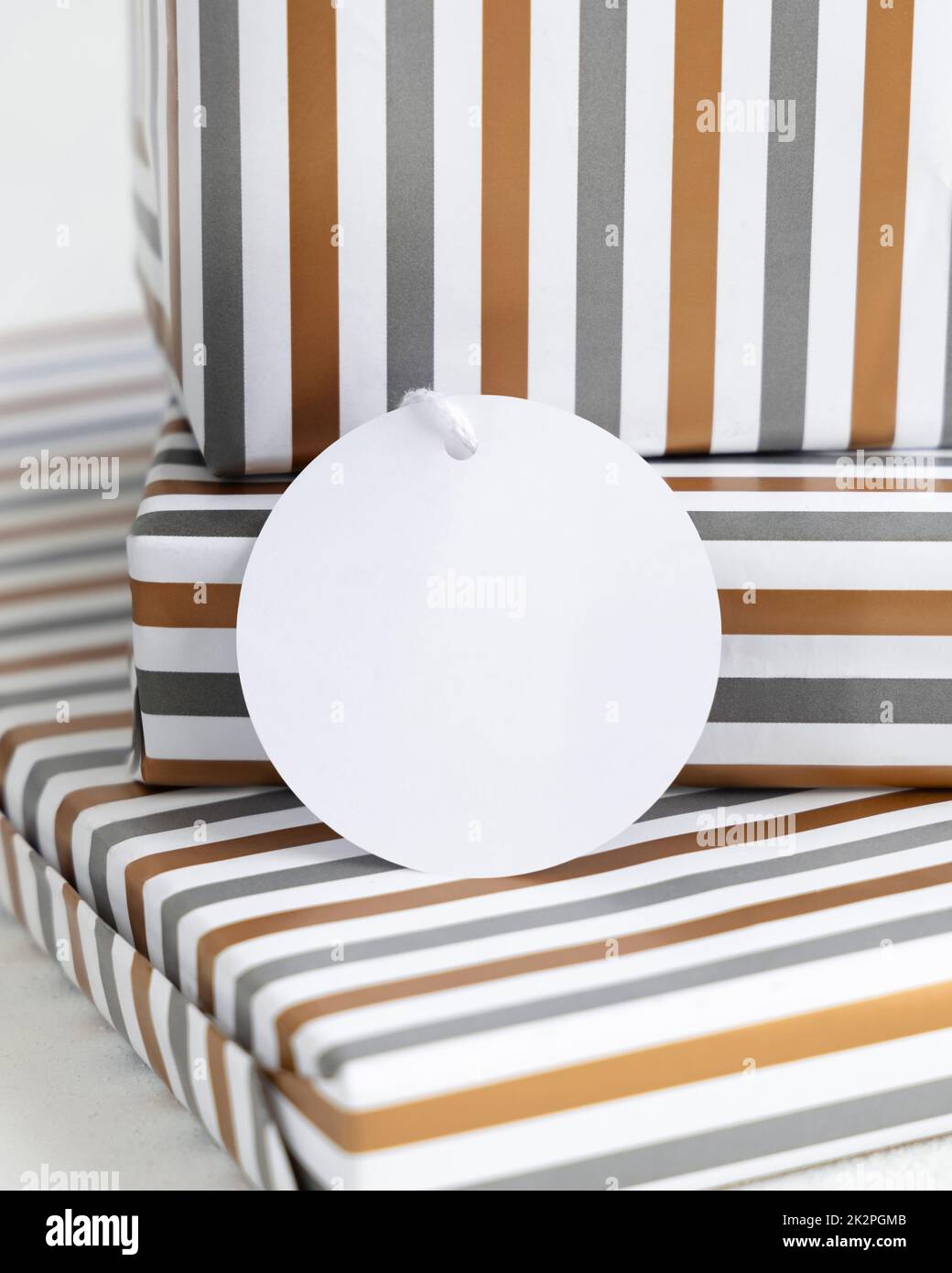 Presents Wrapped in striped paper with blank gift tag close up, label ...