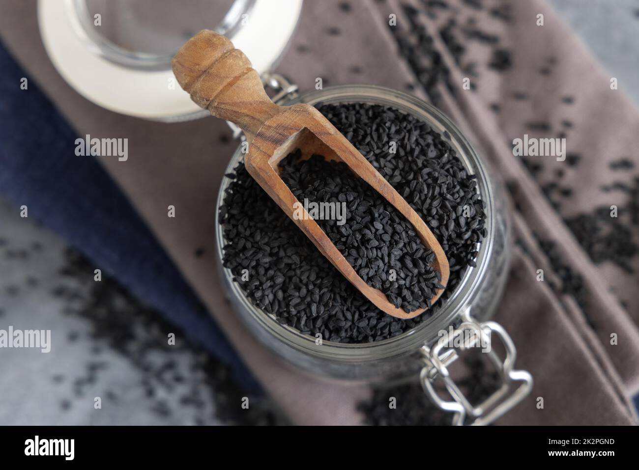 Indian spice Black cumin (nigella sativa or kalonji) seeds in glass jar ...