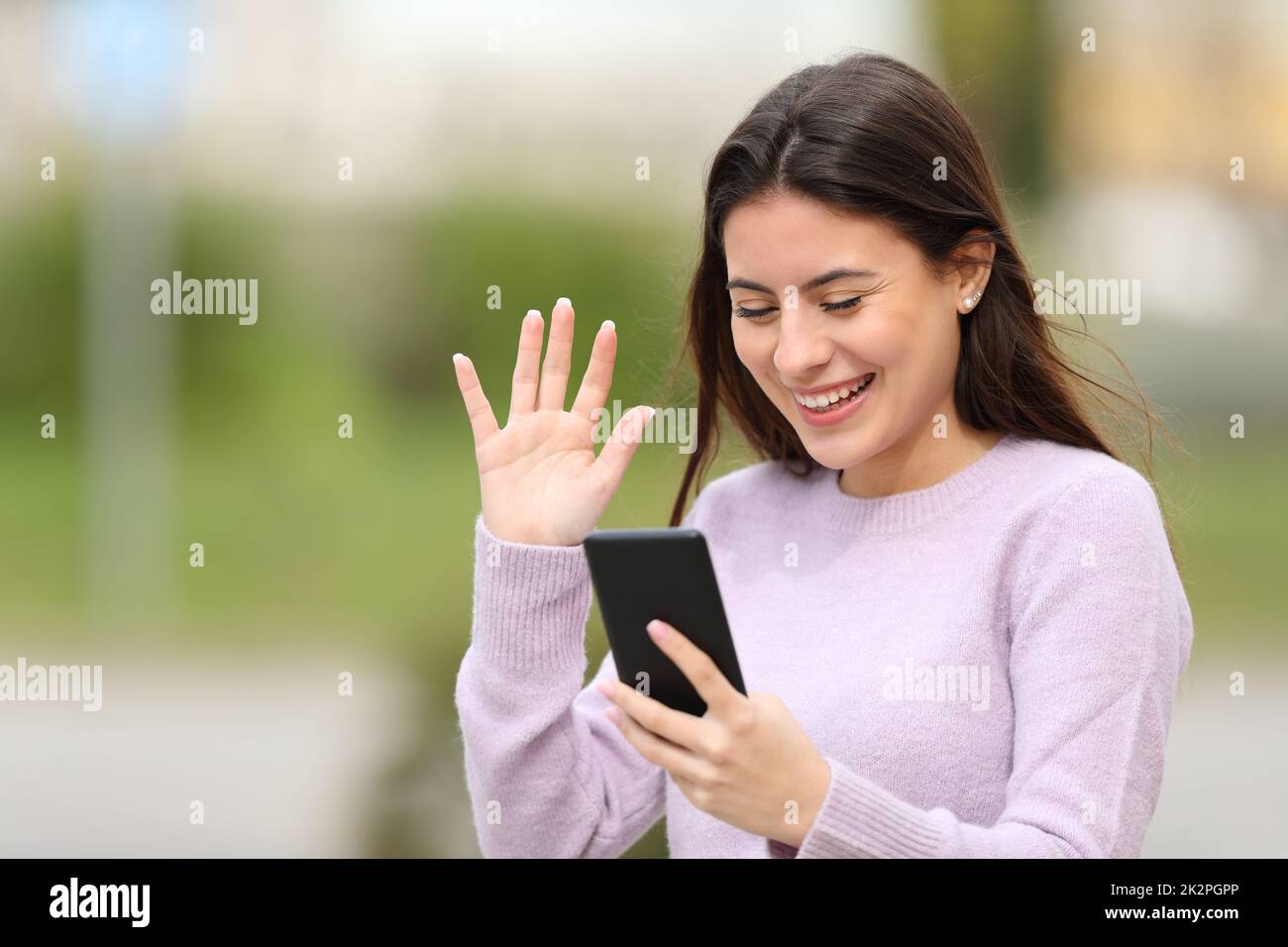 Happy teen greeting during a video call on phone Stock Photo - Alamy